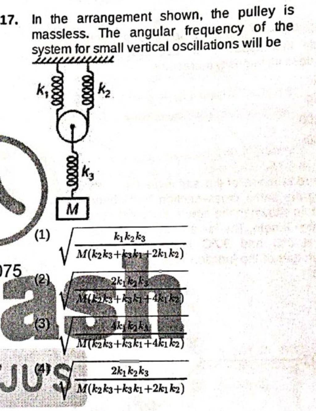 17. In the arrangement shown, the pulley is massless. The angular frequen..