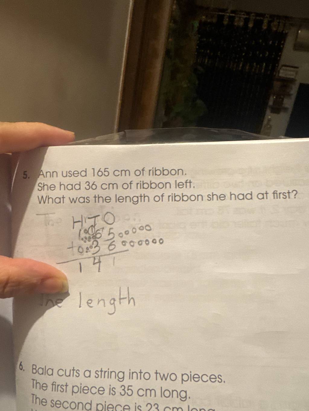 Ann used 165 cm of ribbon. She had 36 cm of ribbon left. What was the len..