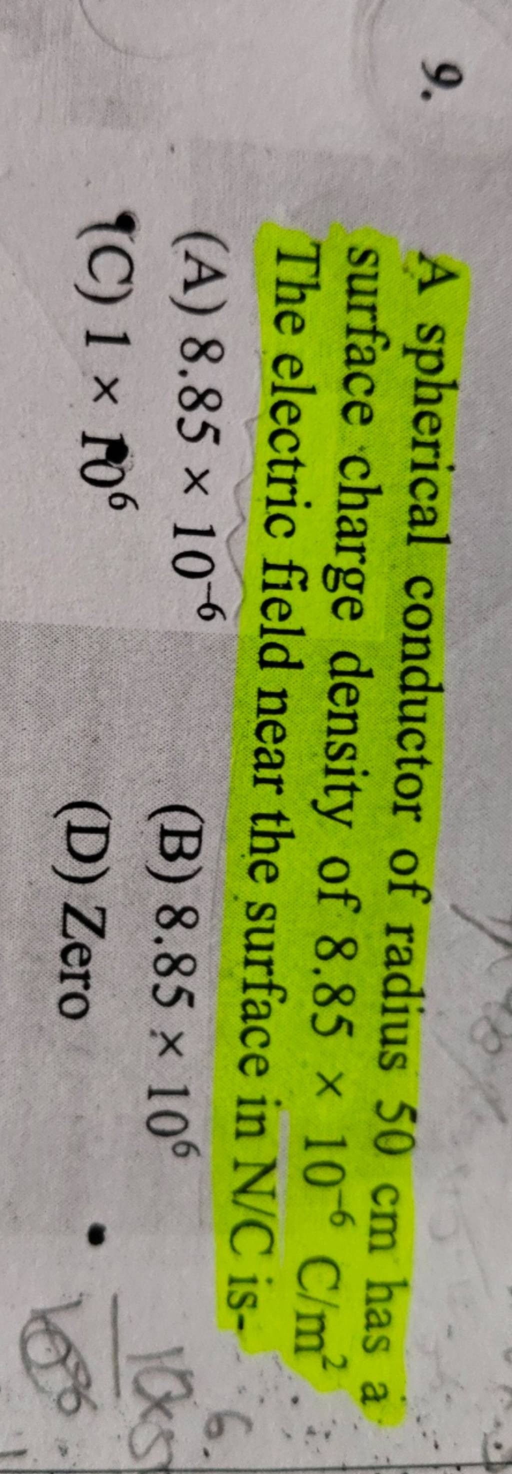 A spherical conductor of radius 50 cm has a surface charge density of 8.8..
